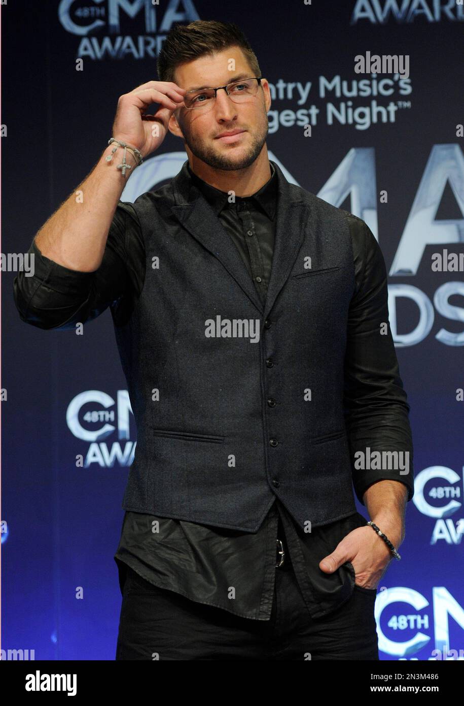 Tim Tebow poses in the press room at the 48th annual CMA Awards at the ...