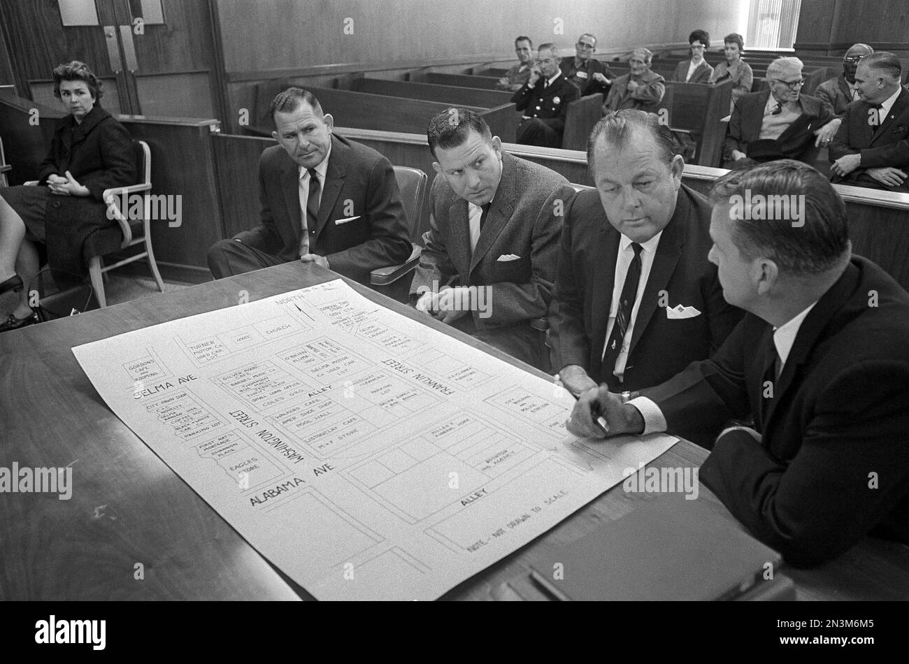 Three defendants go over a street diagram, Dec. 9, 1965, of area in ...
