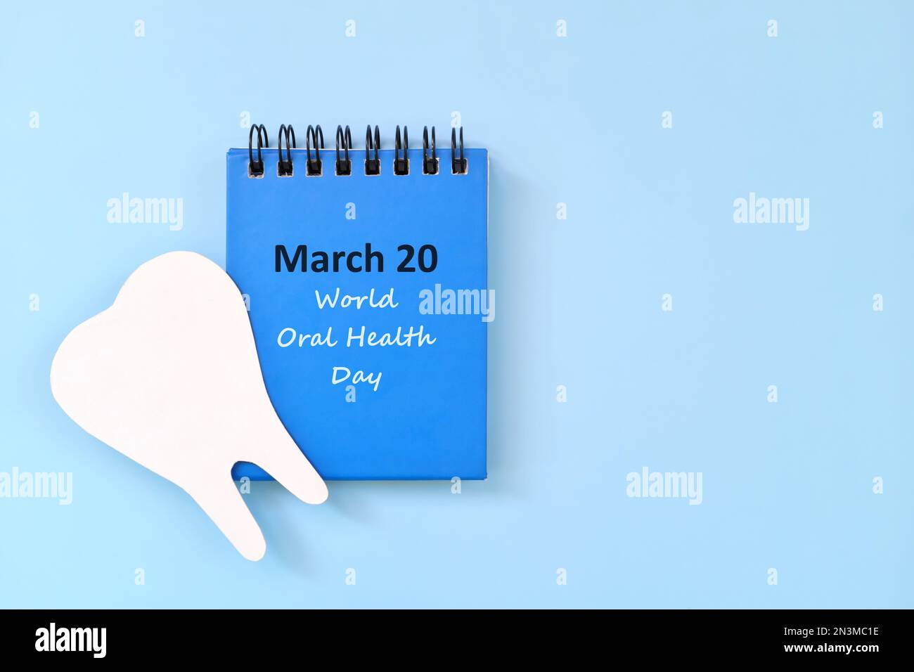 March 20 as World Oral Health Day date reminder on blue desk calendar ...