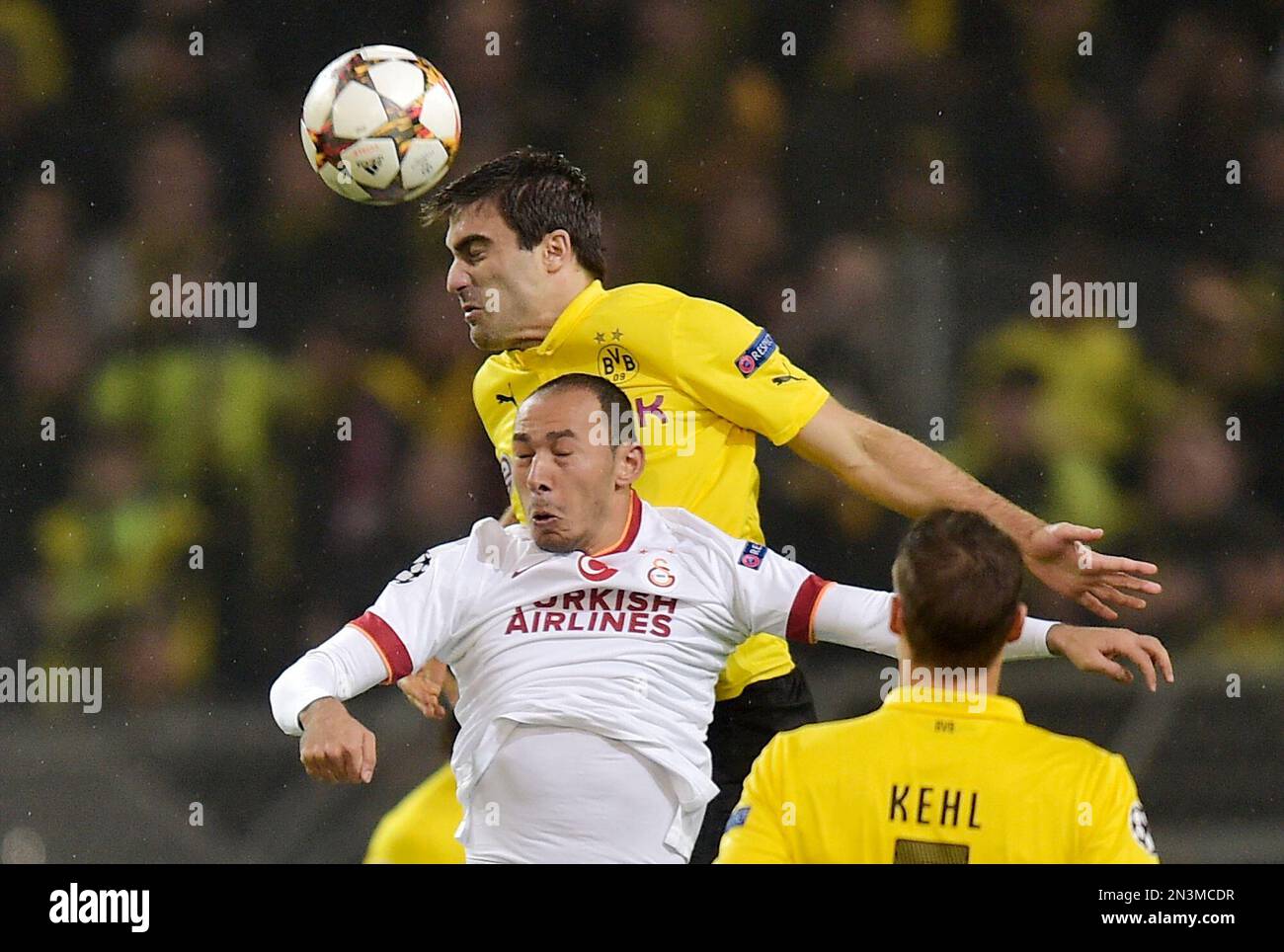Galatasaray's Umut Bulut, front, and Dortmund's Sokratis go for a ...