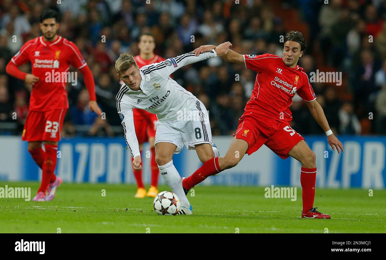 Real Madrid's Toni Kroos, left, battles for the ball with Liverpool's ...