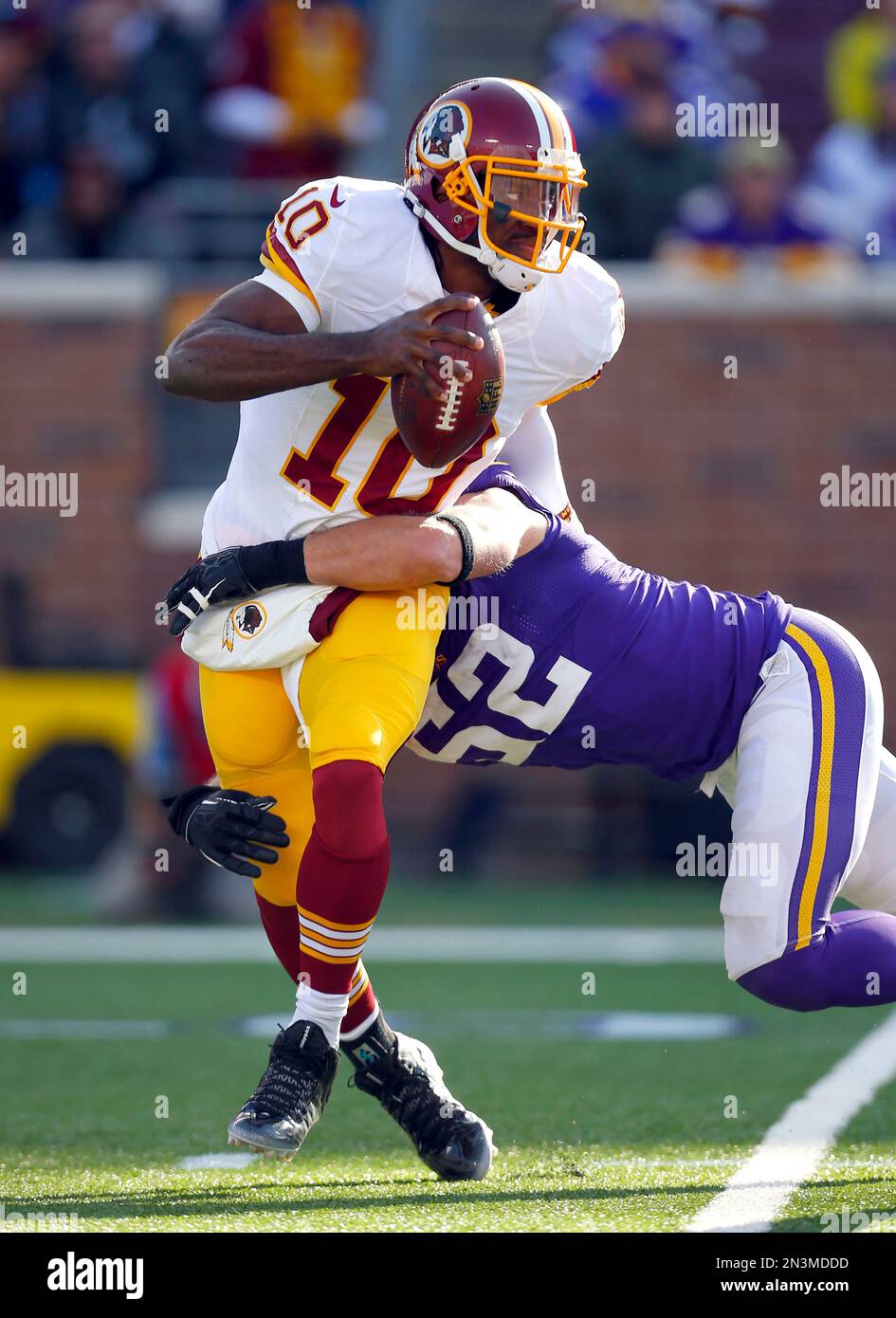 Washington Redskins quarterback Robert Griffin III (10) tries to avoid ...