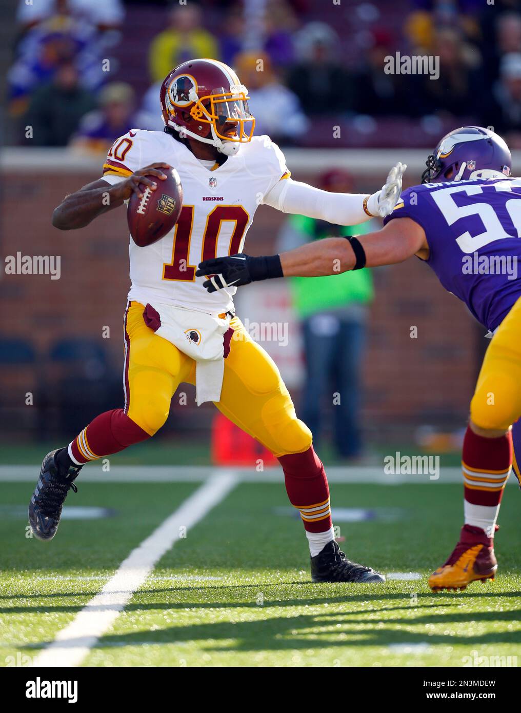Washington Redskins quarterback Robert Griffin III (10) tries to avoid ...