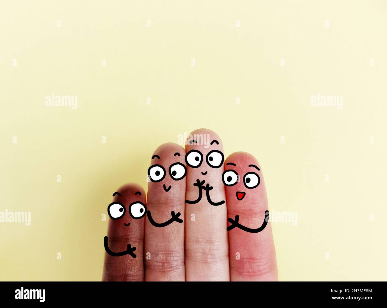 Four fingers are decorated as four person. They are from different ...