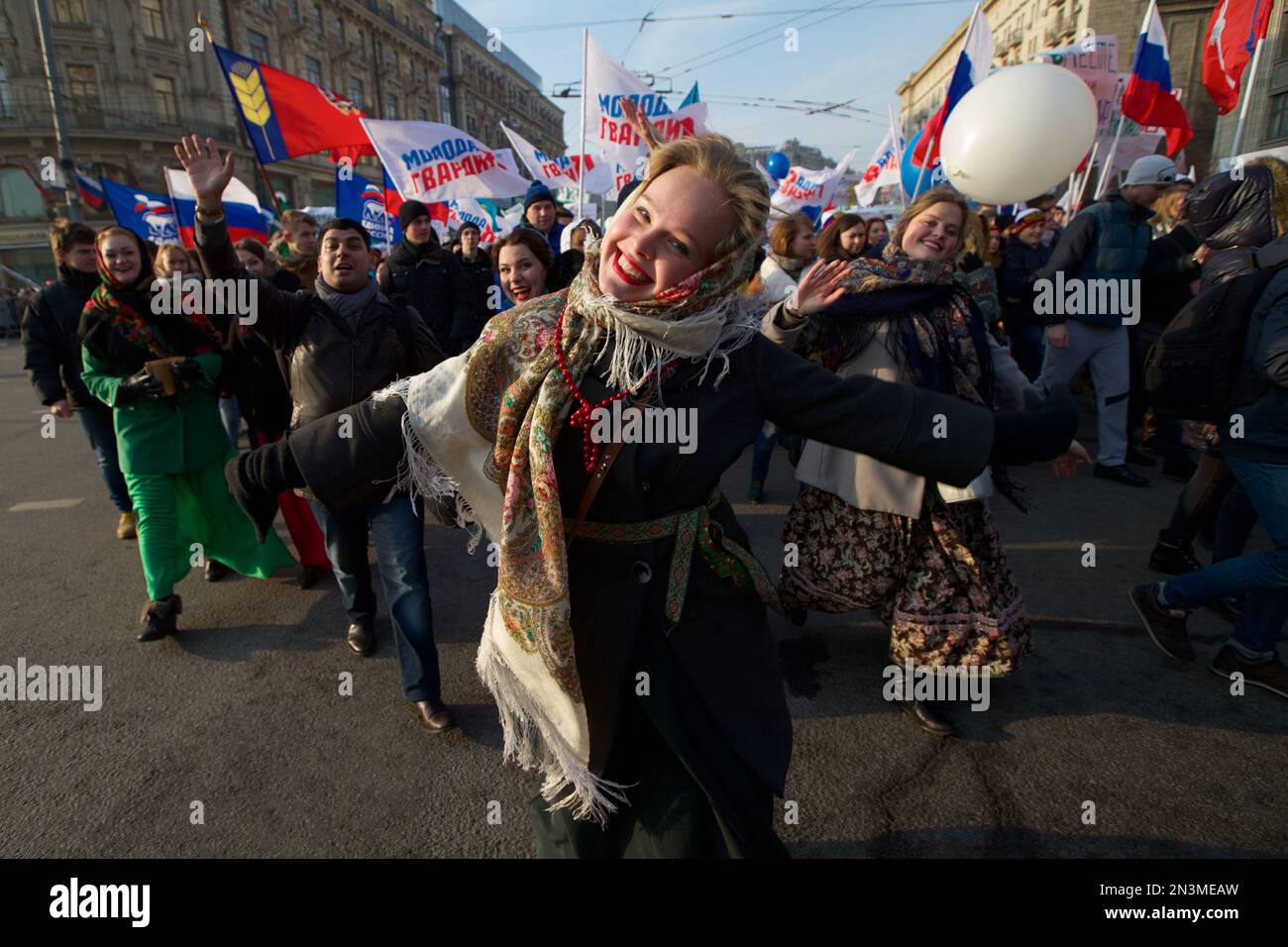 People of pro-government groups, with Russian flags, dance marching ...