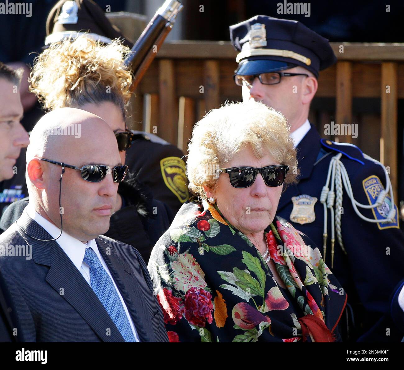 Angela Menino and her son Thomas Jr., watch as the casket of their ...