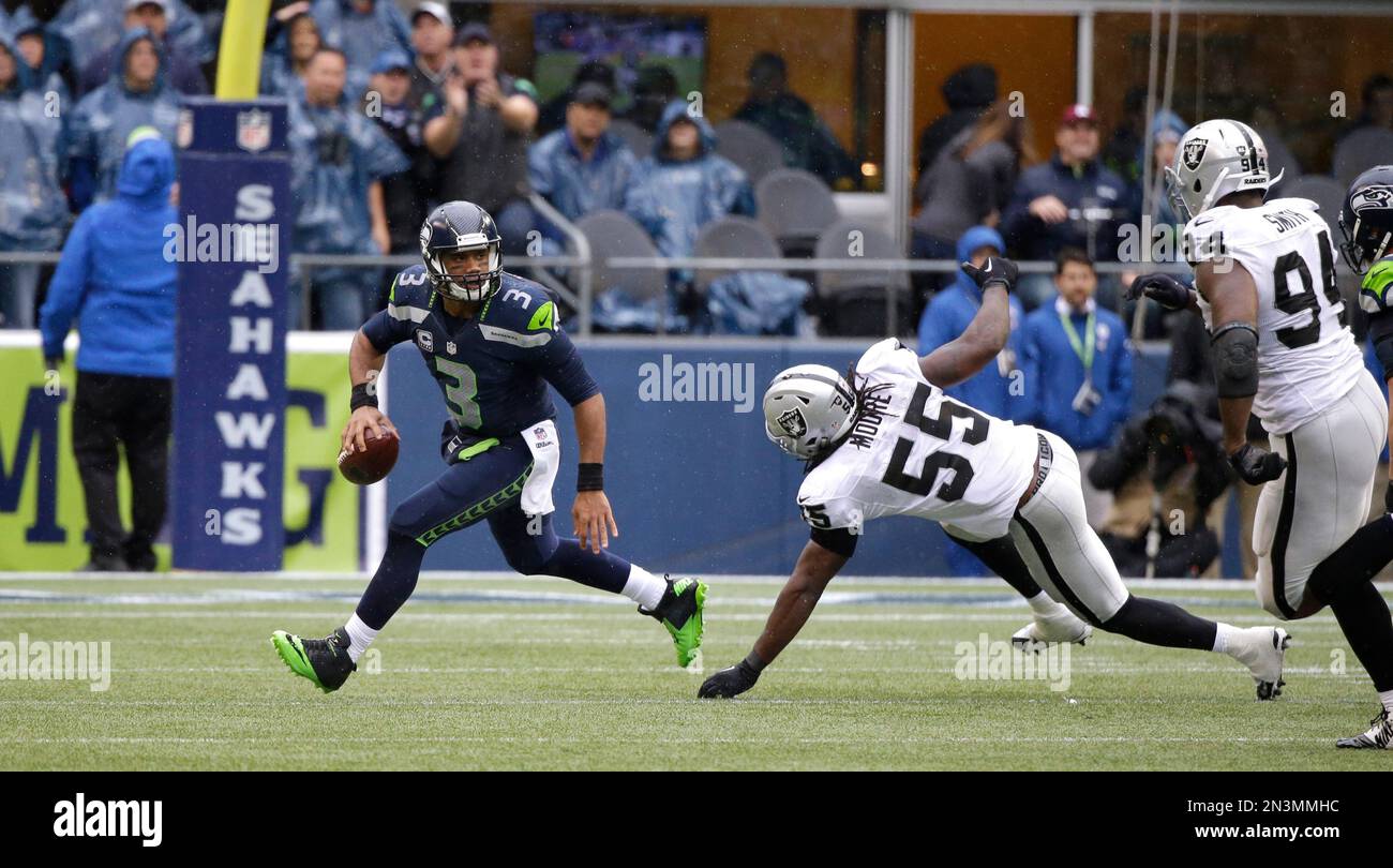 Seattle Seahawks quarterback Russell Wilson (3) dodges a tackle by ...