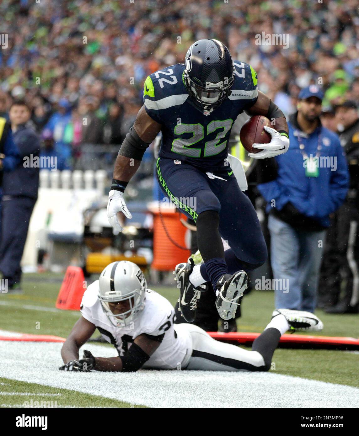 Seattle Seahawks running back Robert Turbin leaps as he carries the ...
