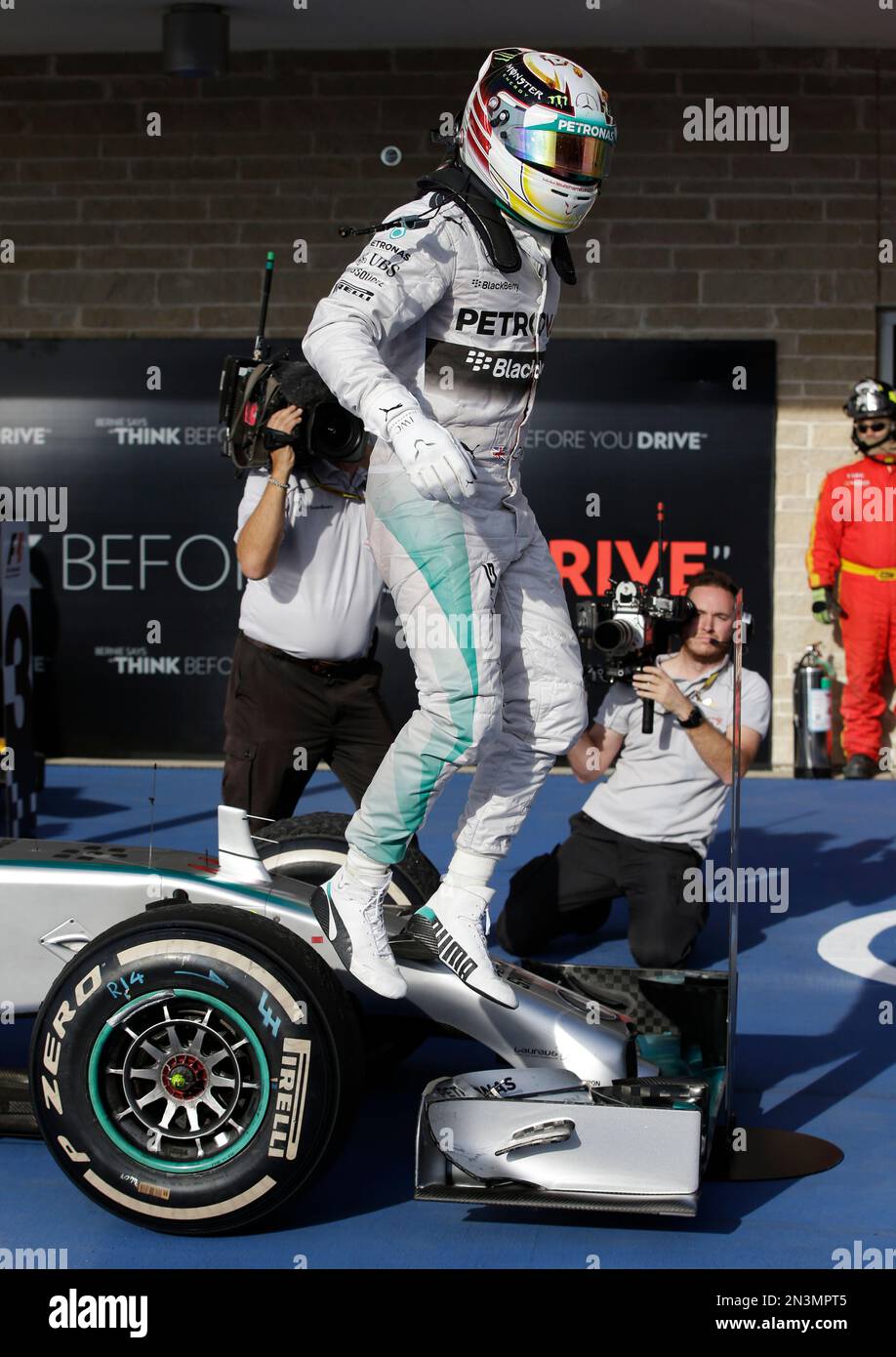 Mercedes driver Lewis Hamilton, of Britain, jumps off his car after ...