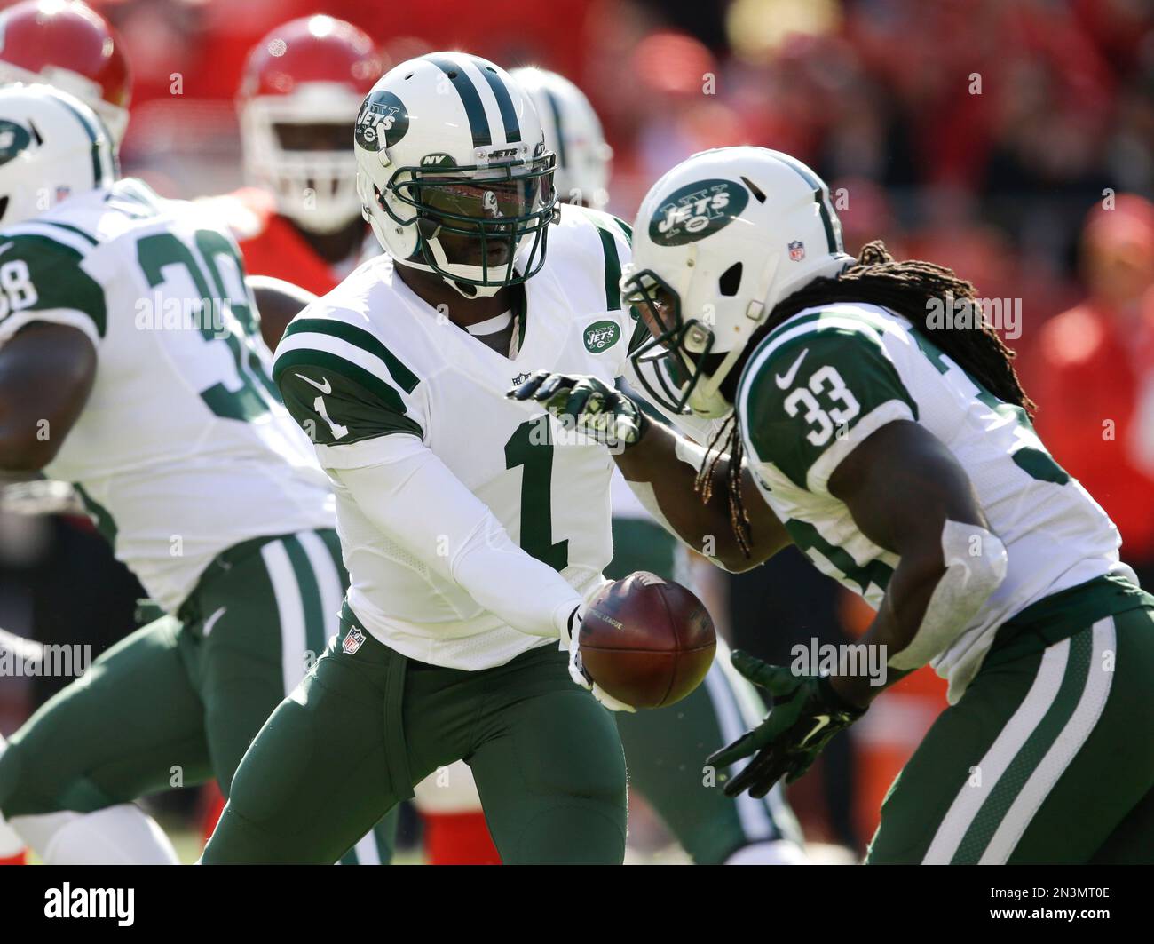 New York Jets quarterback Michael Vick (1) hands off the ball to New ...