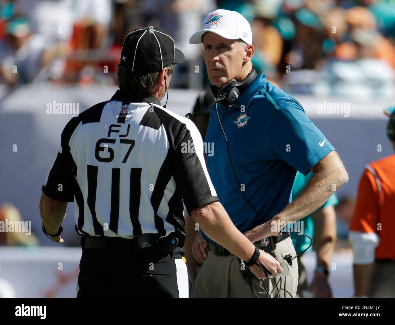 Miami Dolphins head coach Joe Philbin listens to field judge Doug ...