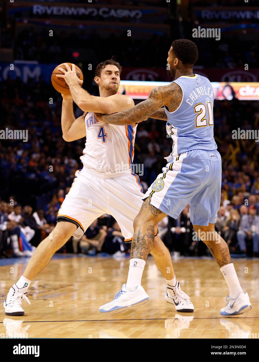 Oklahoma City Thunder Nick Collison (4) goes against Denver Nuggets3 ...