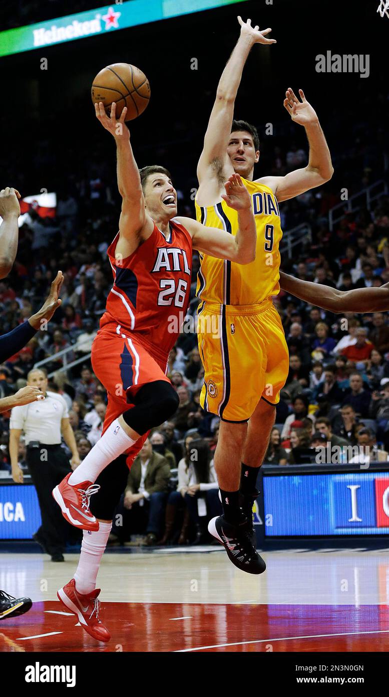 Atlanta Hawks' Kyle Korver, left, puts up a shot against Indiana Pacers ...