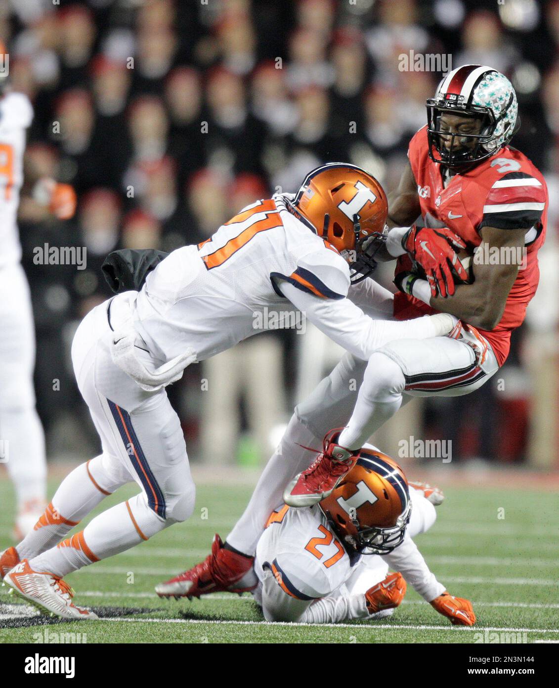 Ohio State wide receiver Michael Thomas, right, is tackled by Illinois ...
