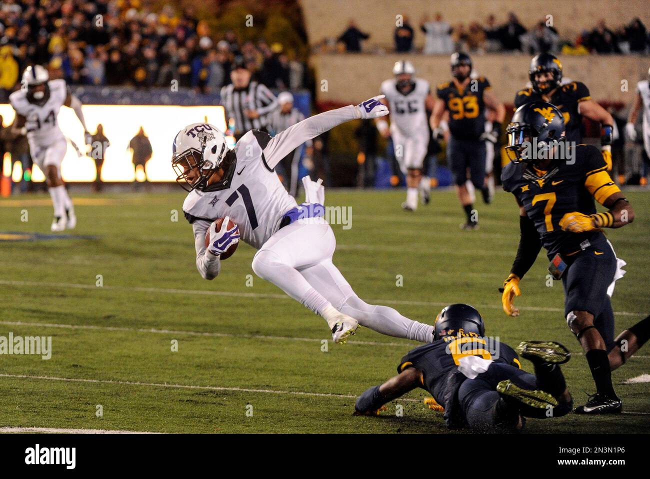 TCU's Kolby Listenbee (7) is tackeled by West Virginia defender Dravon ...