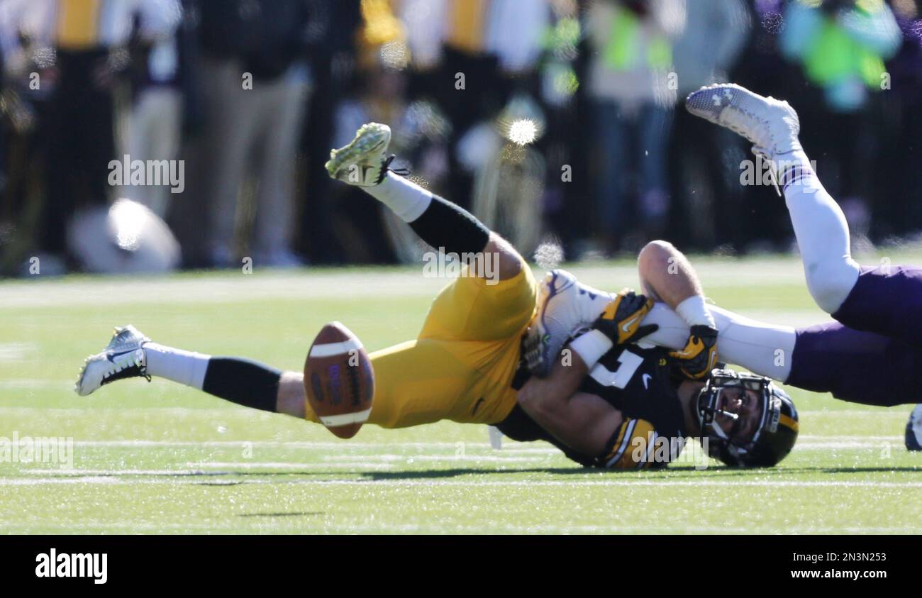Iowa defensive back John Lowdermilk (37) holds onto the legs of ...