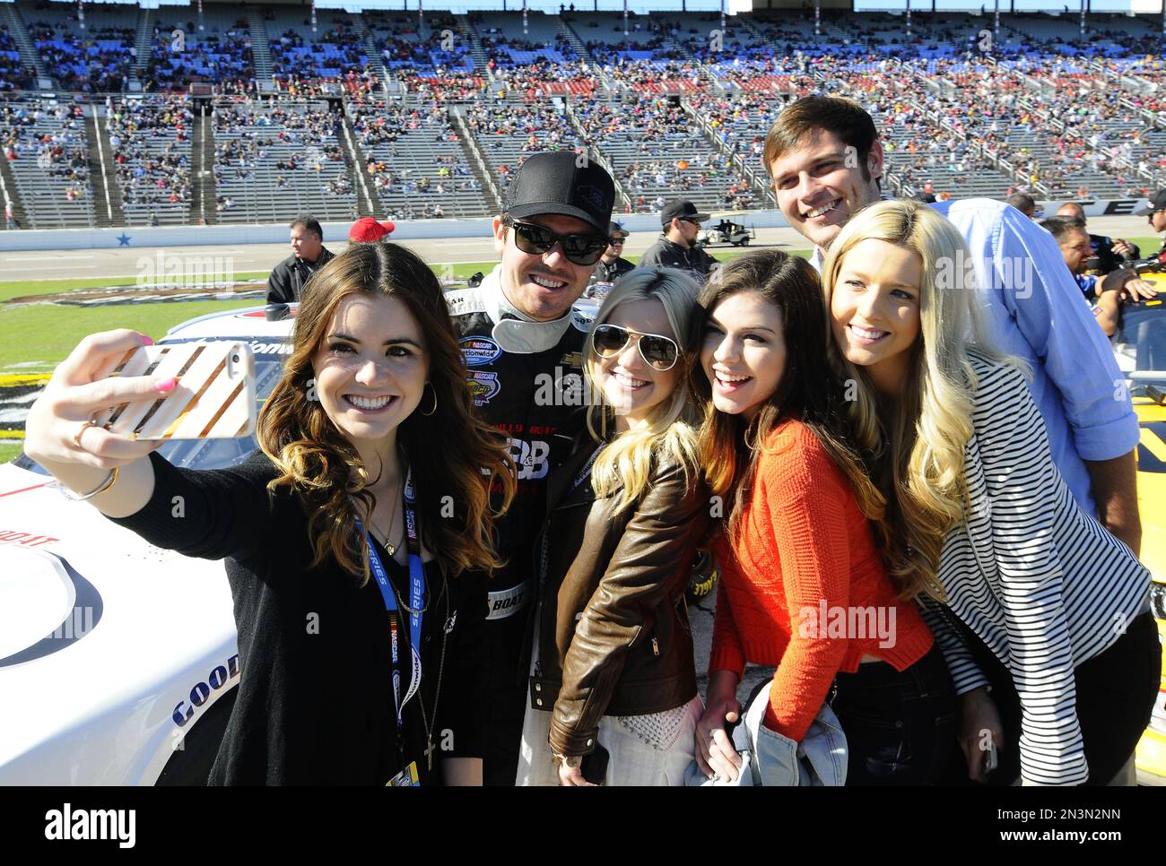 Driver Chad Boat, second from left, posses for a cell phone photo with ...