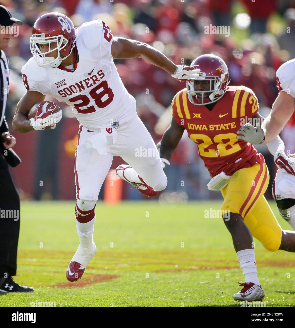 Oklahoma running back Alex Ross (28) runs from Iowa State defensive ...