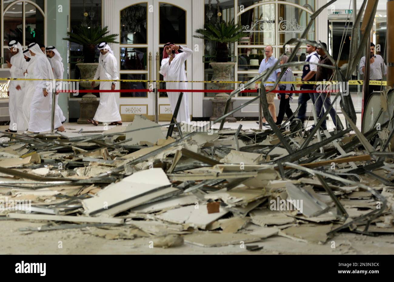 Bahraini police and officials view damage caused by a partial roof ...