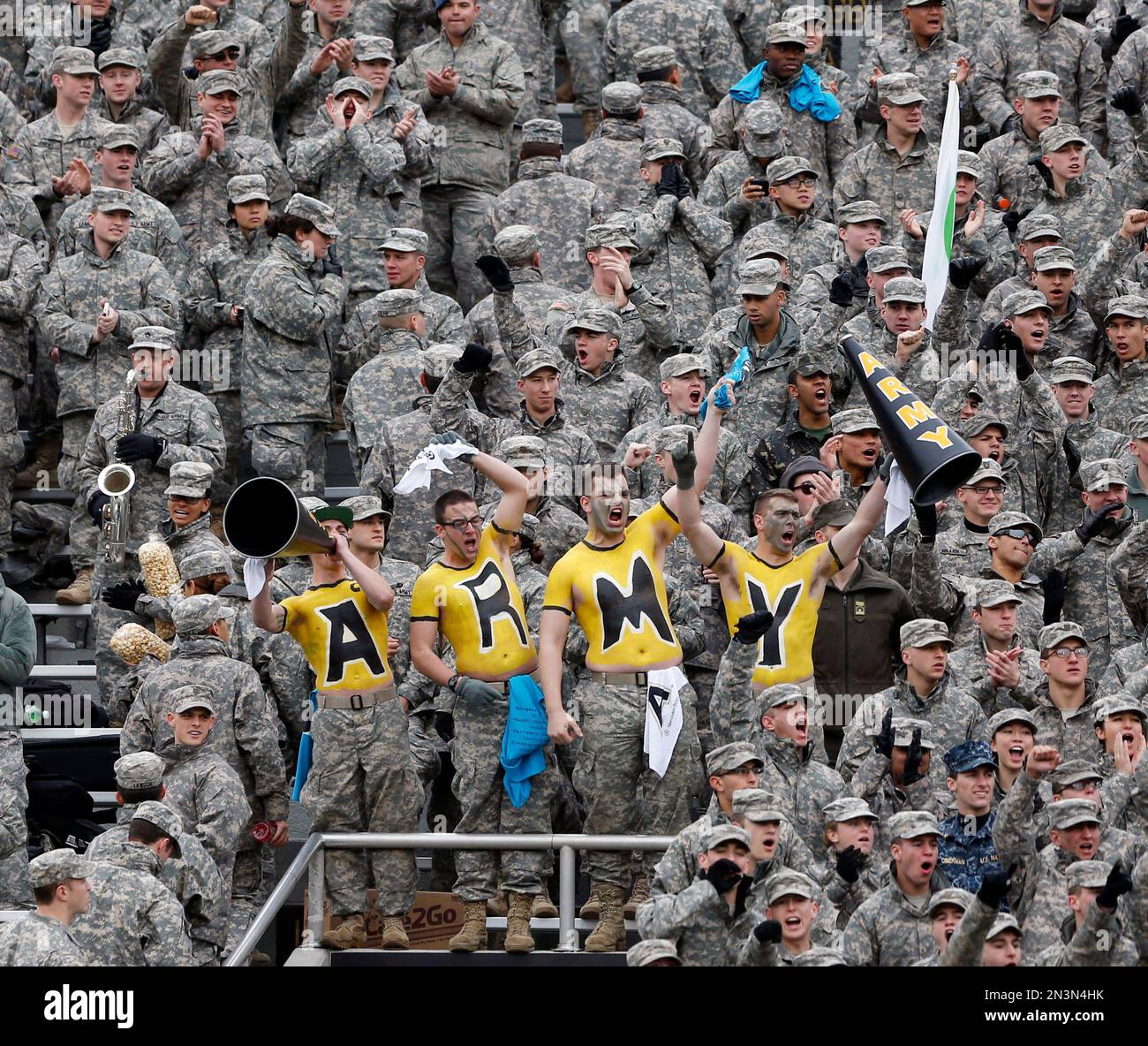 Cadets cheer during the first half of an NCAA college football game ...