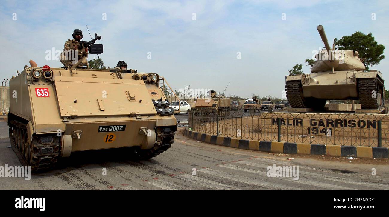 Pakistani army troops ride military vehicles as they leave the Malir ...