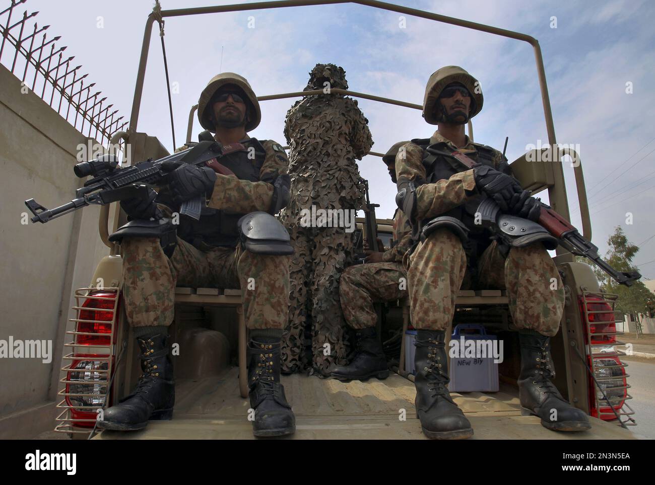 Pakistani army troops keep position on a vehicle as they leave the ...