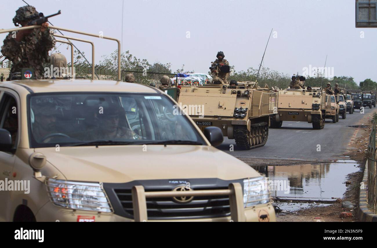 Pakistani army troops ride military vehicles as they leave the Malir ...