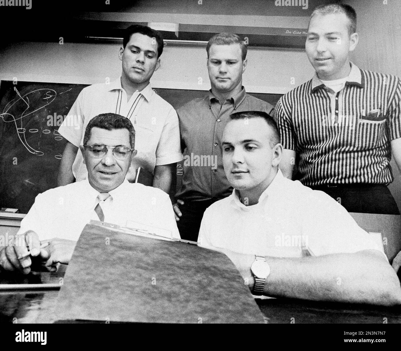 Green Bay Packers coach Vince Lombardi, seated left, goes over some ...