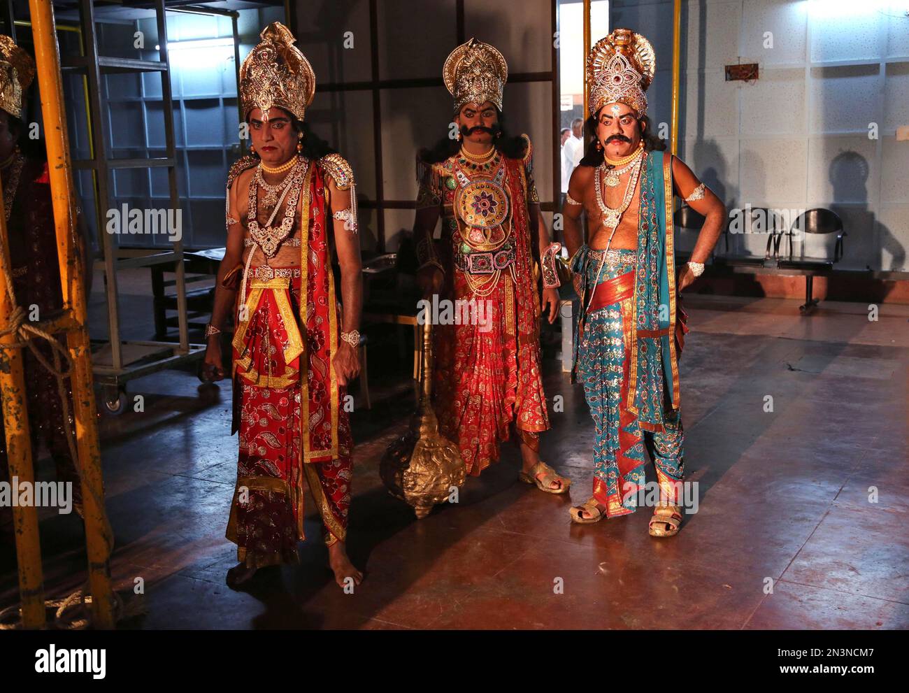 Indian actors dressed as Hindu mythological characters wait backstage ...