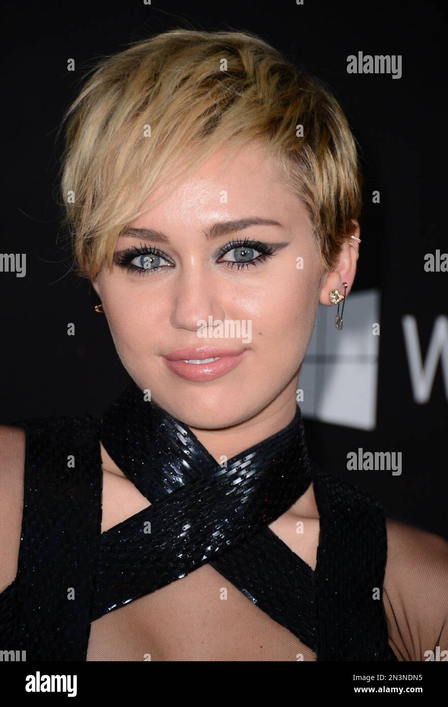 Miley Cyrus arrives at the 2014 amfAR Inspiration Gala at Milk Studios ...