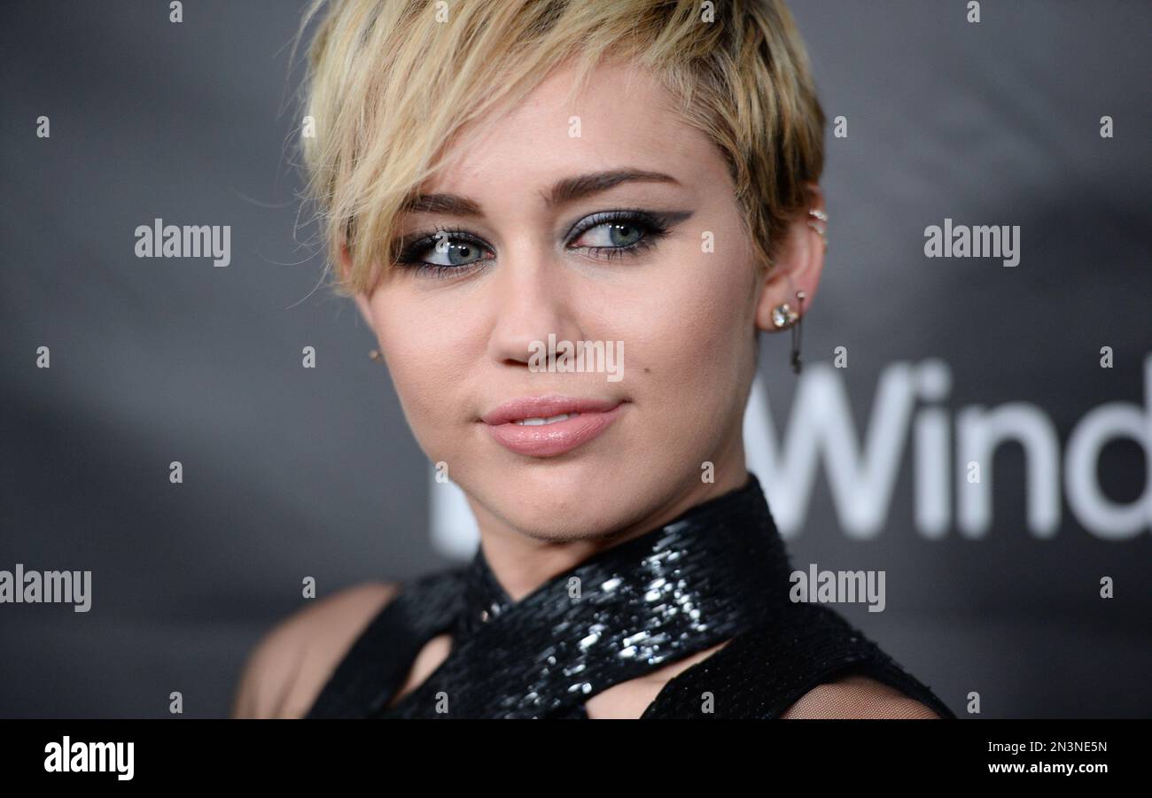 Miley Cyrus arrives at the 2014 amfAR Inspiration Gala at Milk Studios ...