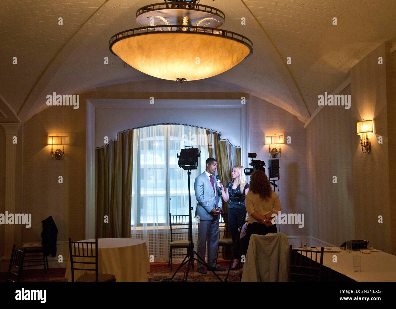 UConn head coach Kevin Ollie, left, is interviewed during the American ...
