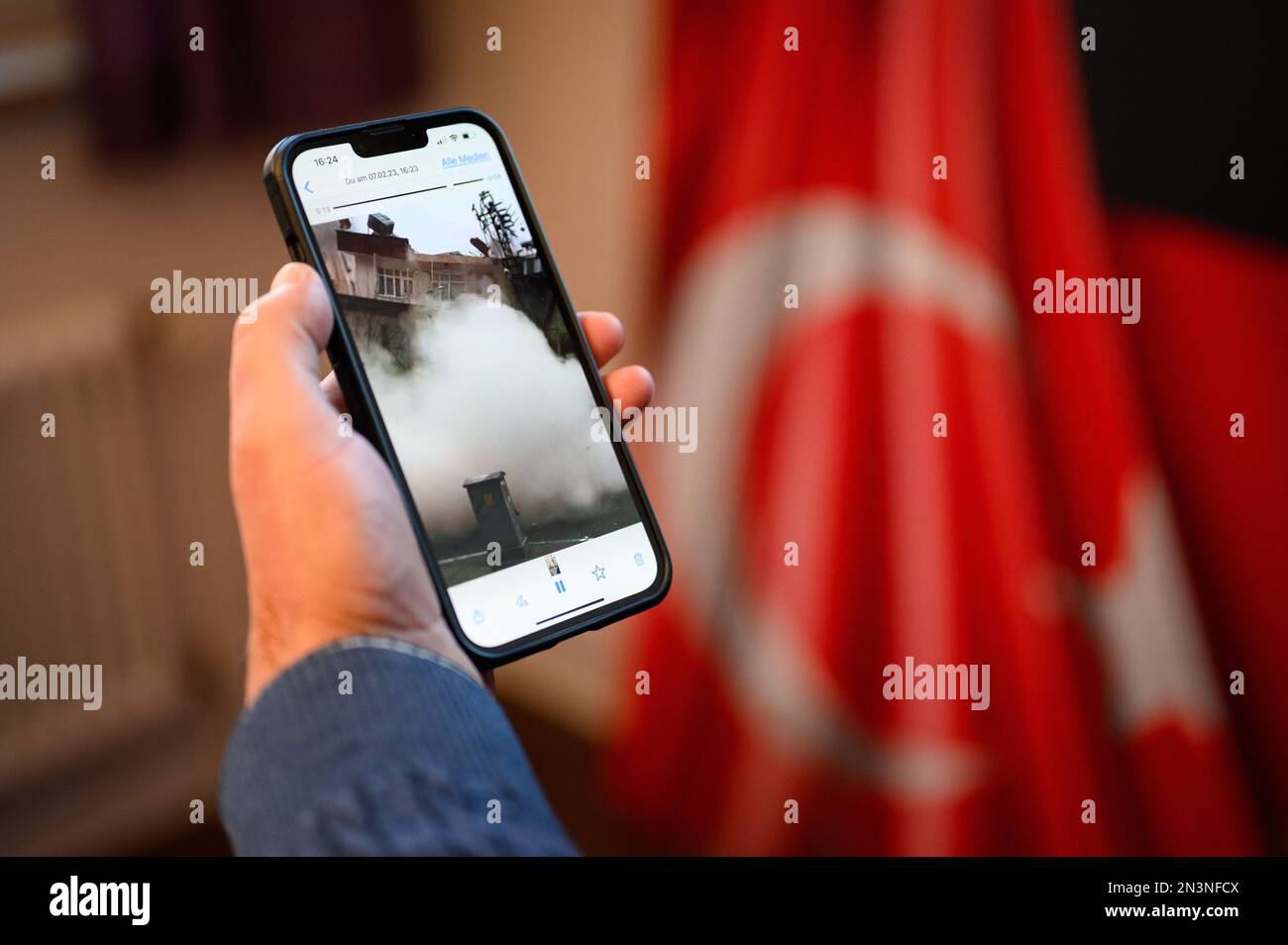 Hamburg, Germany. 07th Feb, 2023. A man shows the video of a collapsing ...