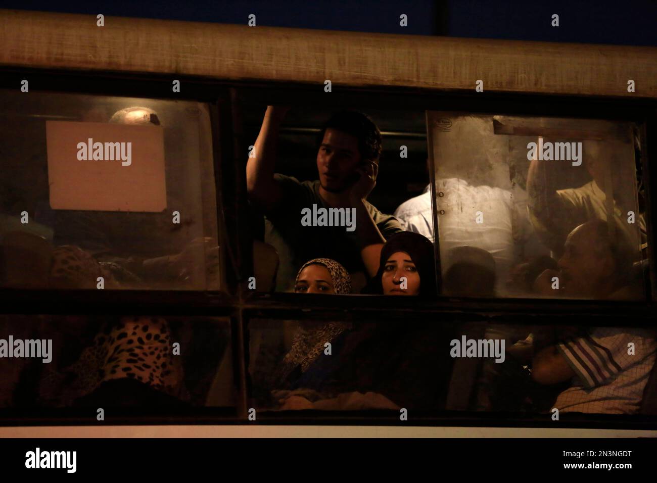 Egyptian commuters on a bus get stuck in a traffic jam during rush hour ...