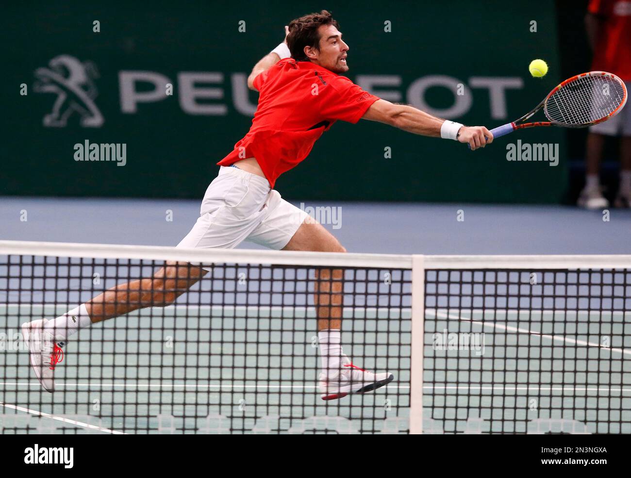 Jeremy Chardy of France returns the ball to Roger Federer of ...