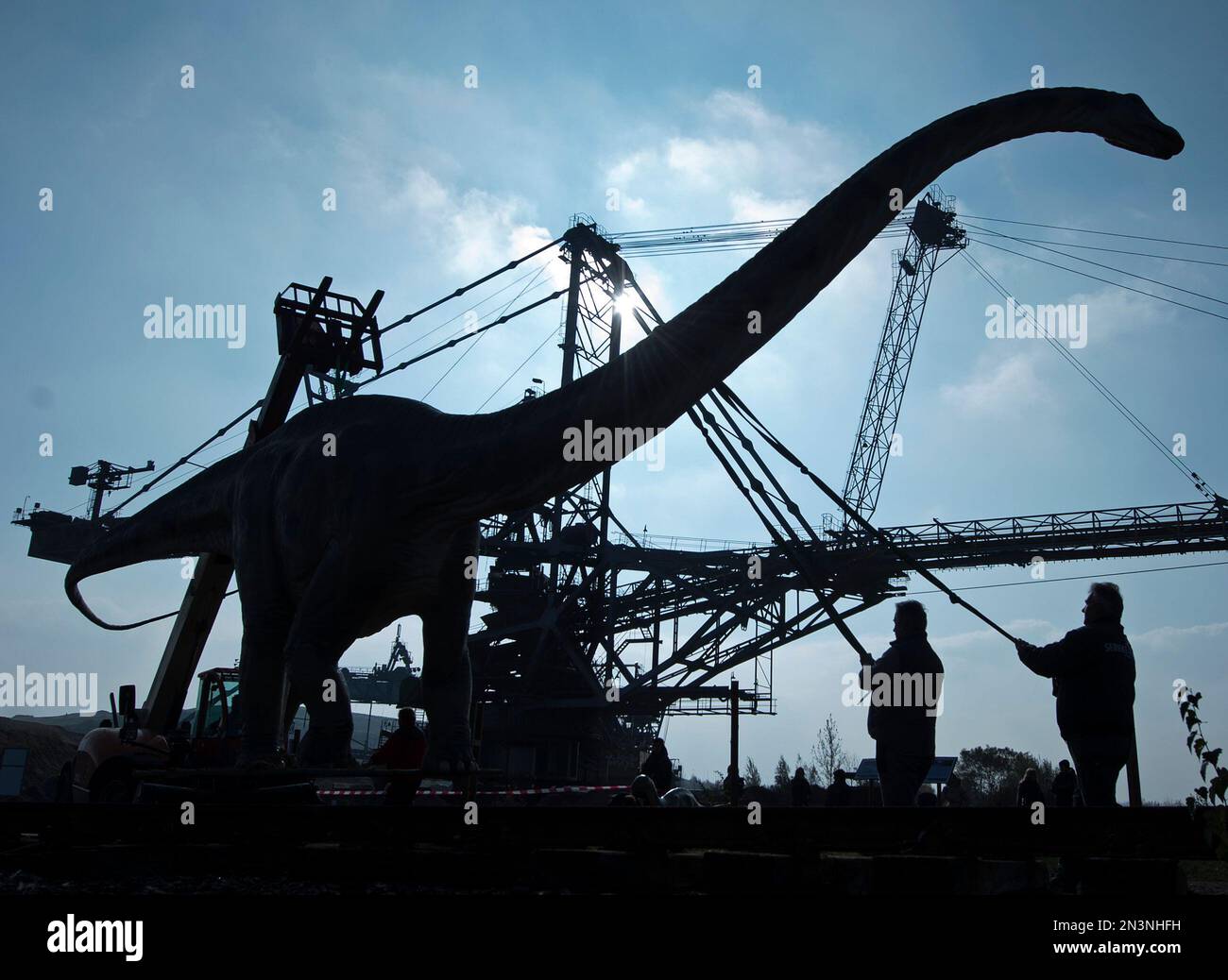 Workers transport a model of a dinosaur at the exhibition 'World of ...