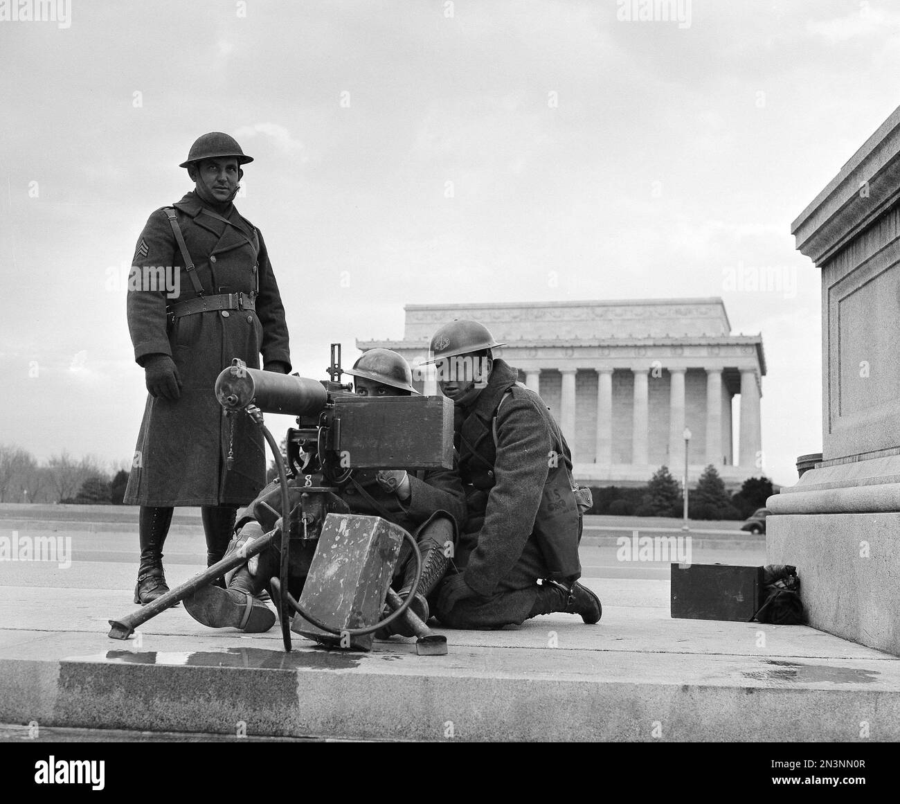 Soldiers with a machine gun set up near the Lincoln Memorial to guard ...