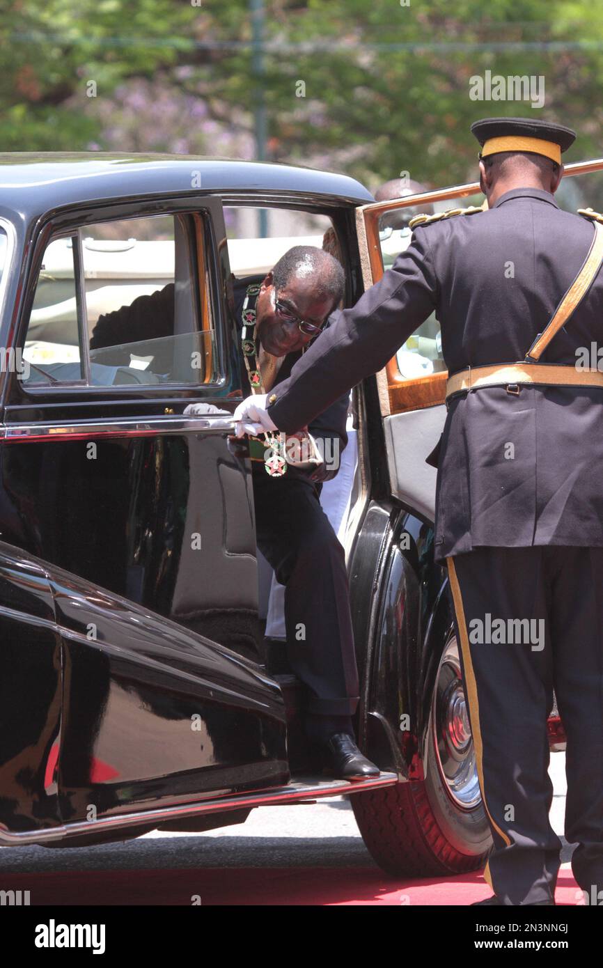 Zimbabwe President Robert Mugabe gets out of his vintage Rolls Royce ...