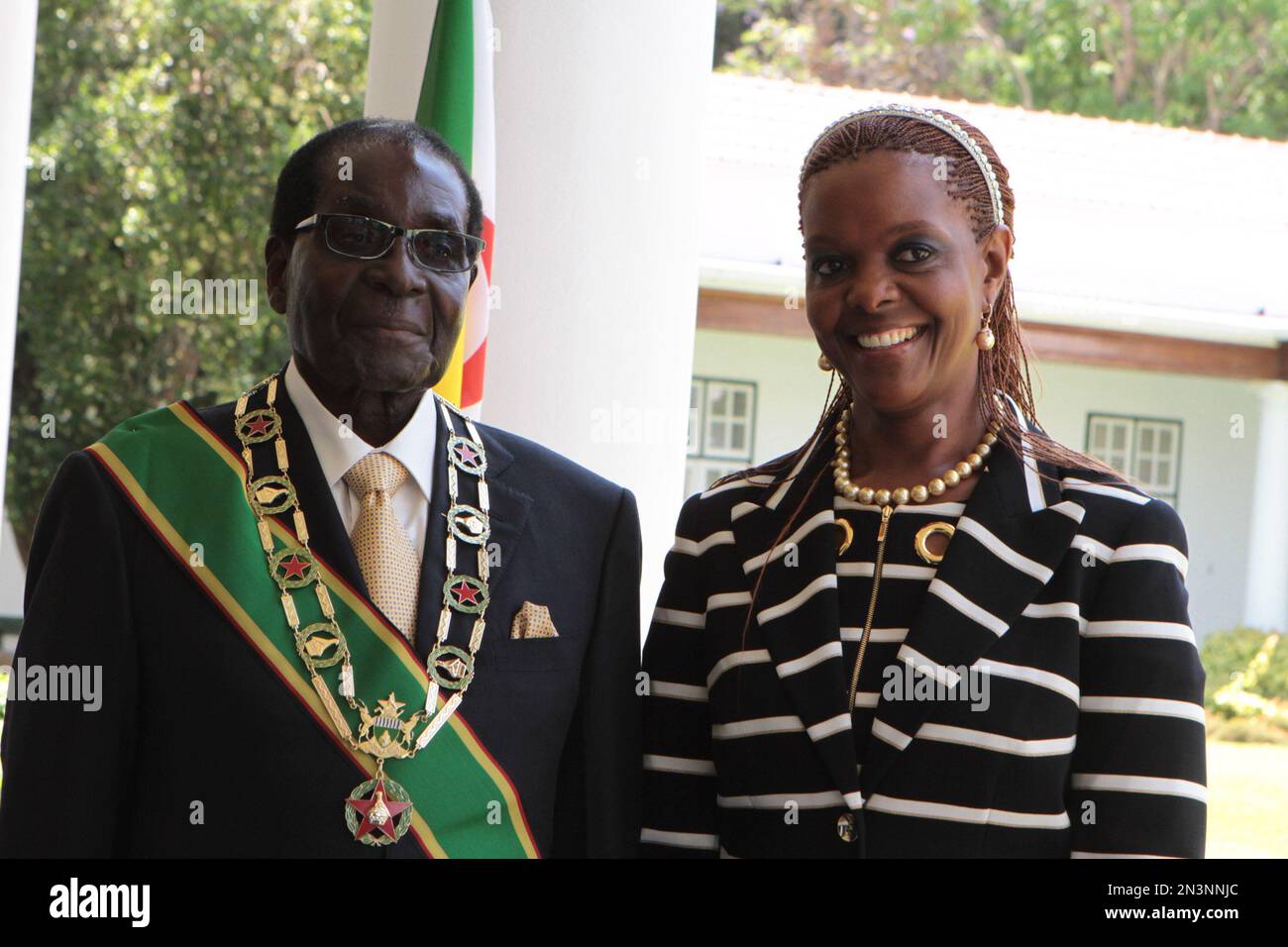 Zimbabwe President Robert Mugabe stands with his wife Grace, as they ...