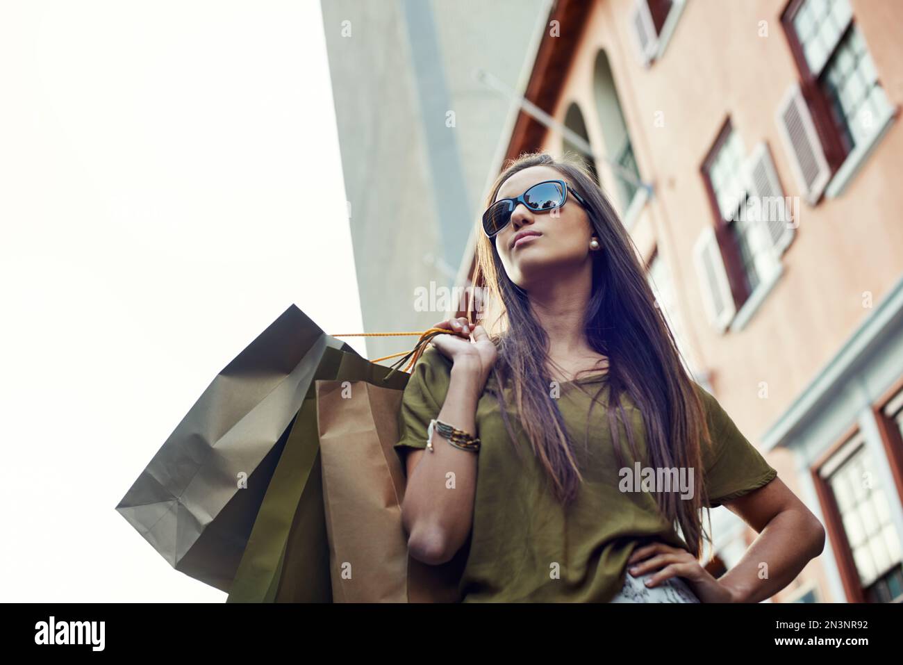 Always on trend. A young woman out shopping and looking stylish as she ...
