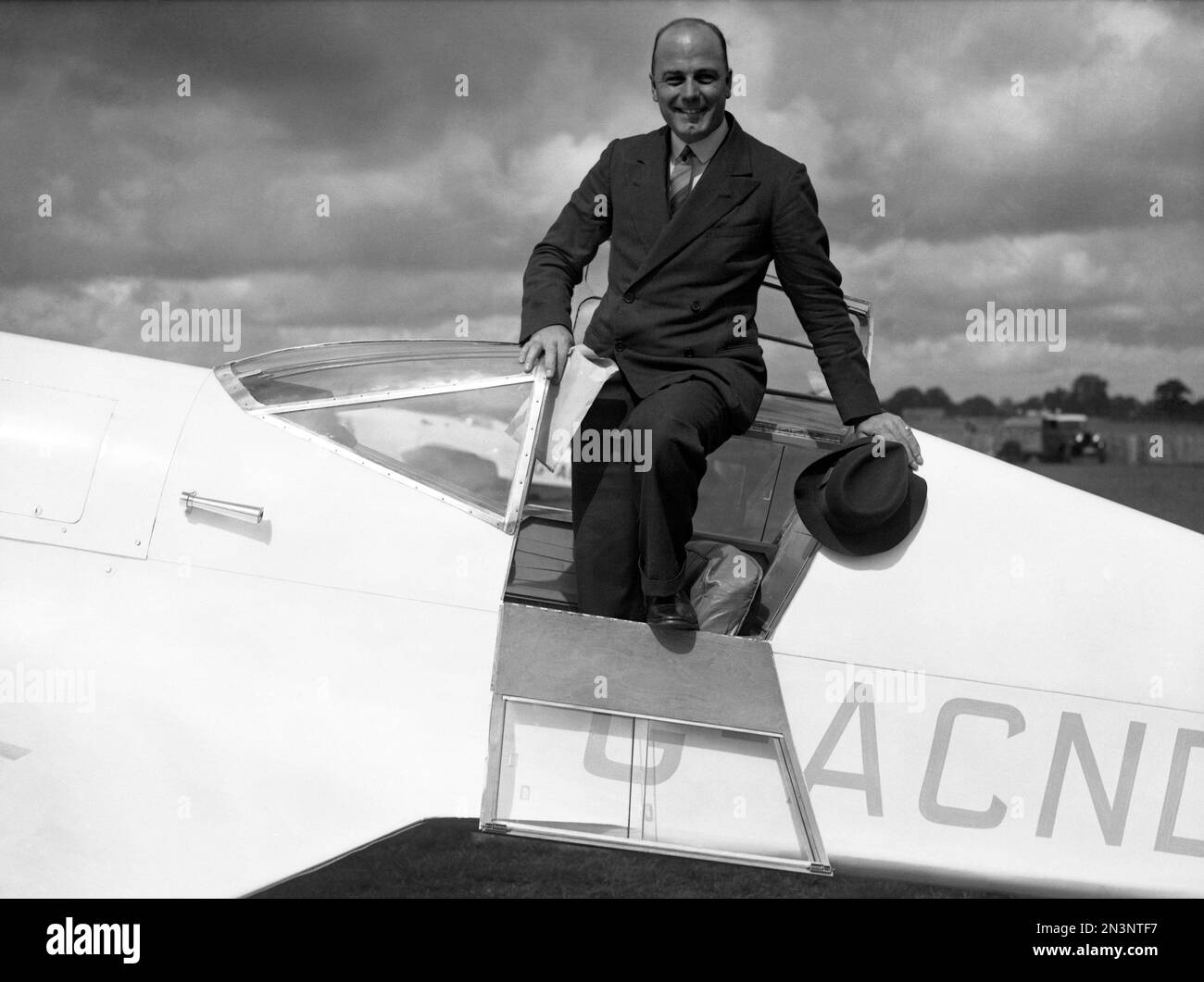 Edward Percival alighting from a plane on arrival at Hatfield Aerodrome ...