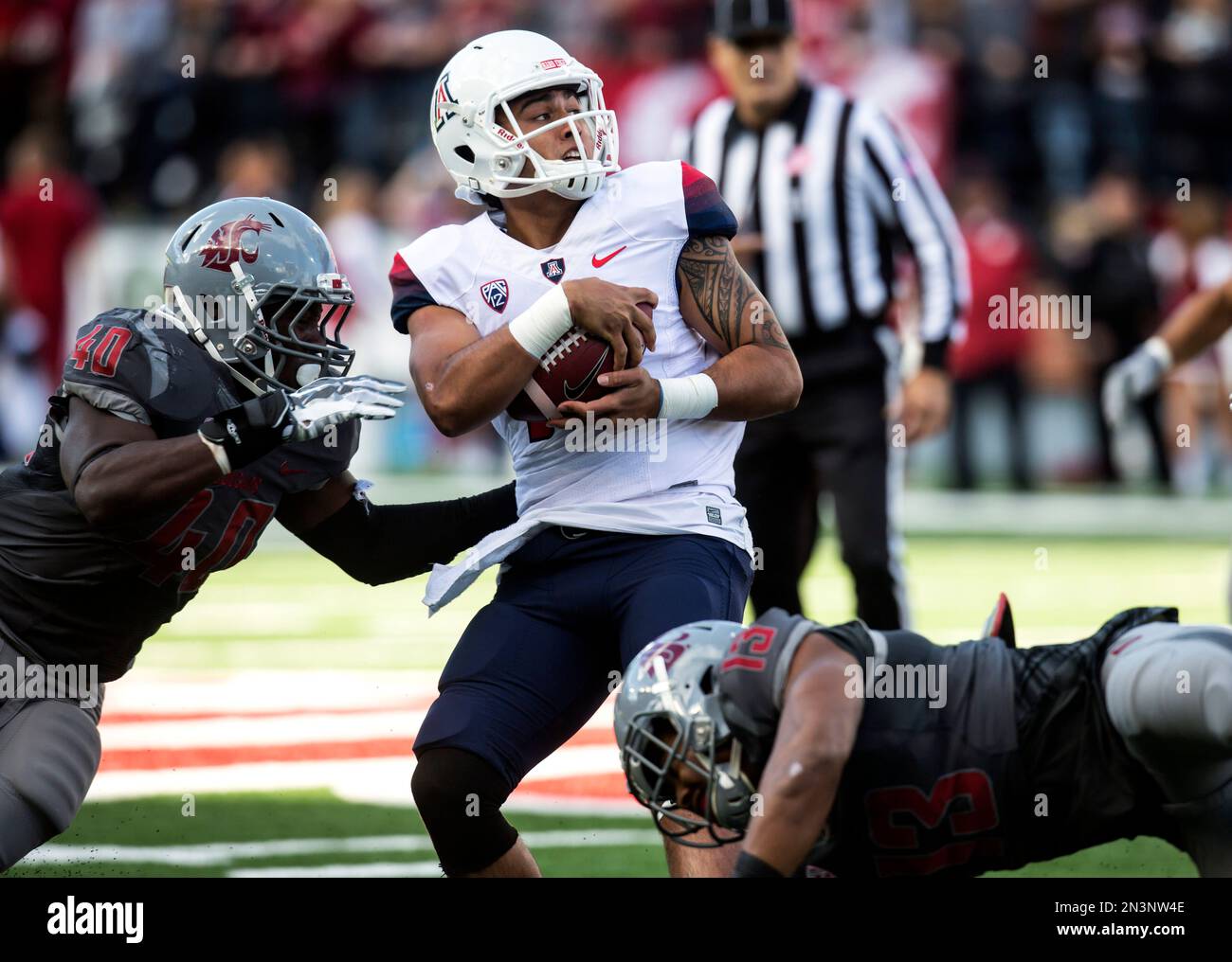 Arizona quarterback Anu Solomon (12) spins out of the tackle attempts ...