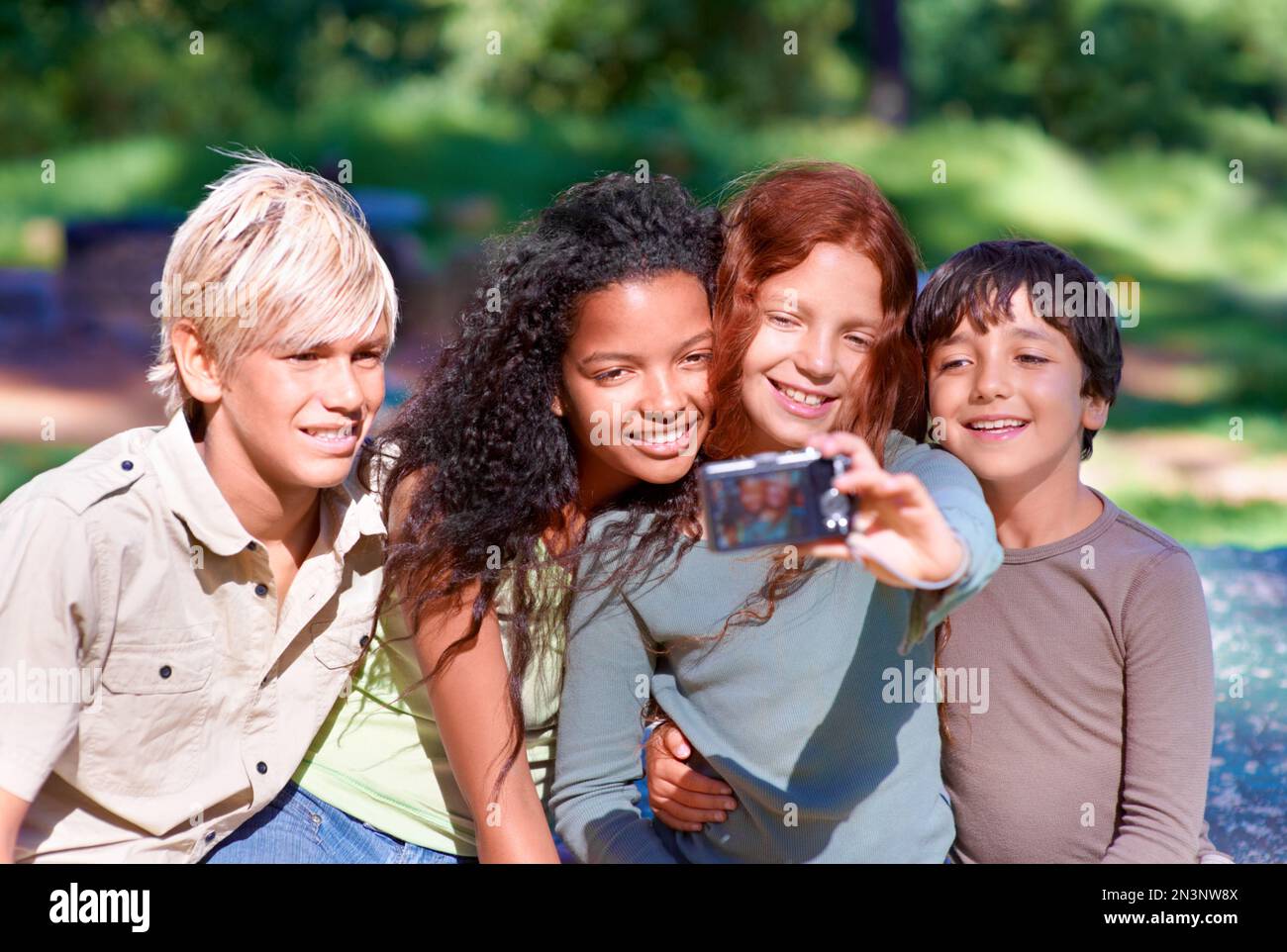 Capture a moment in time. A group of kids taking a selfportrait with a ...