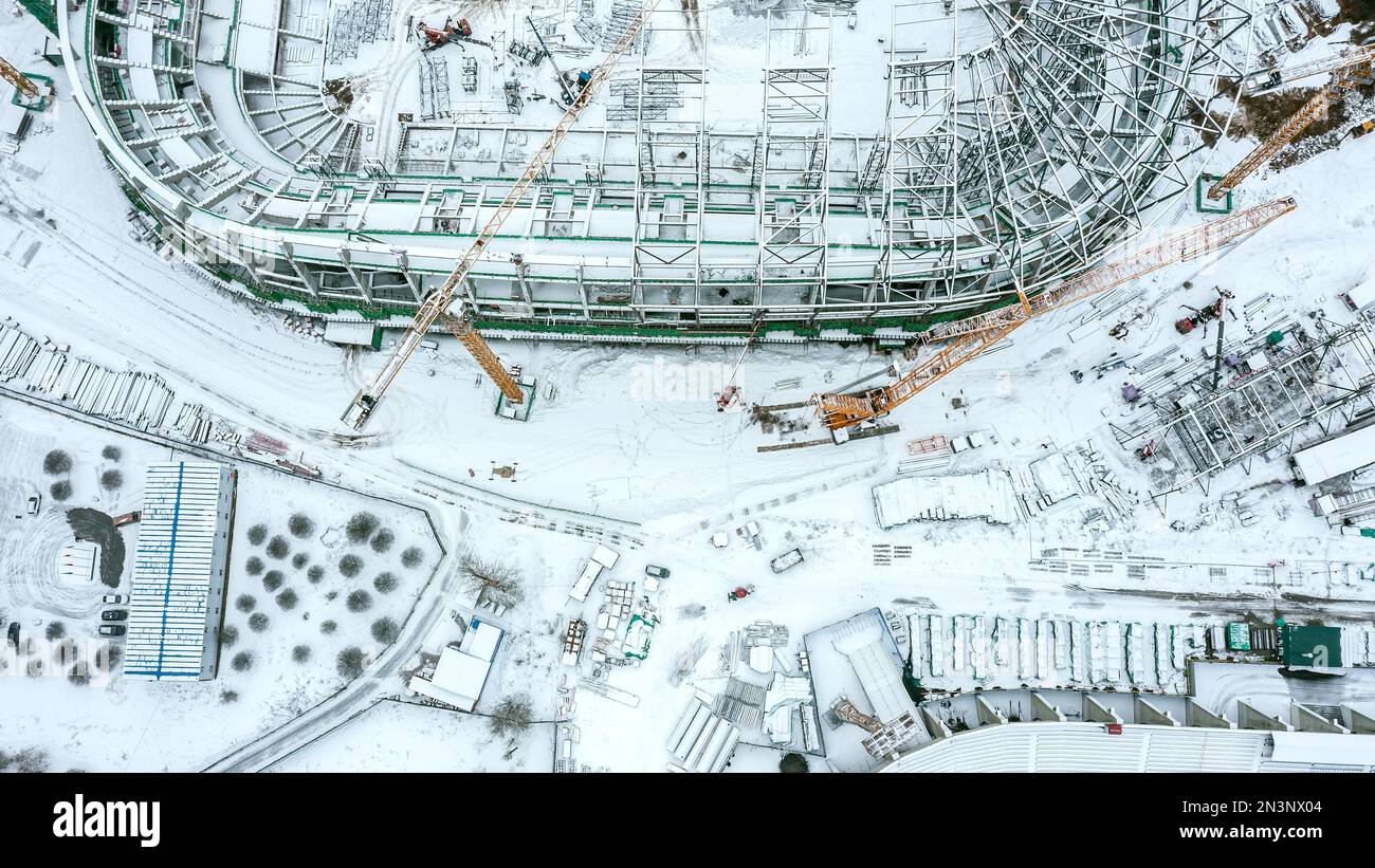 snow-covered construction site in winter. tower crane and building ...