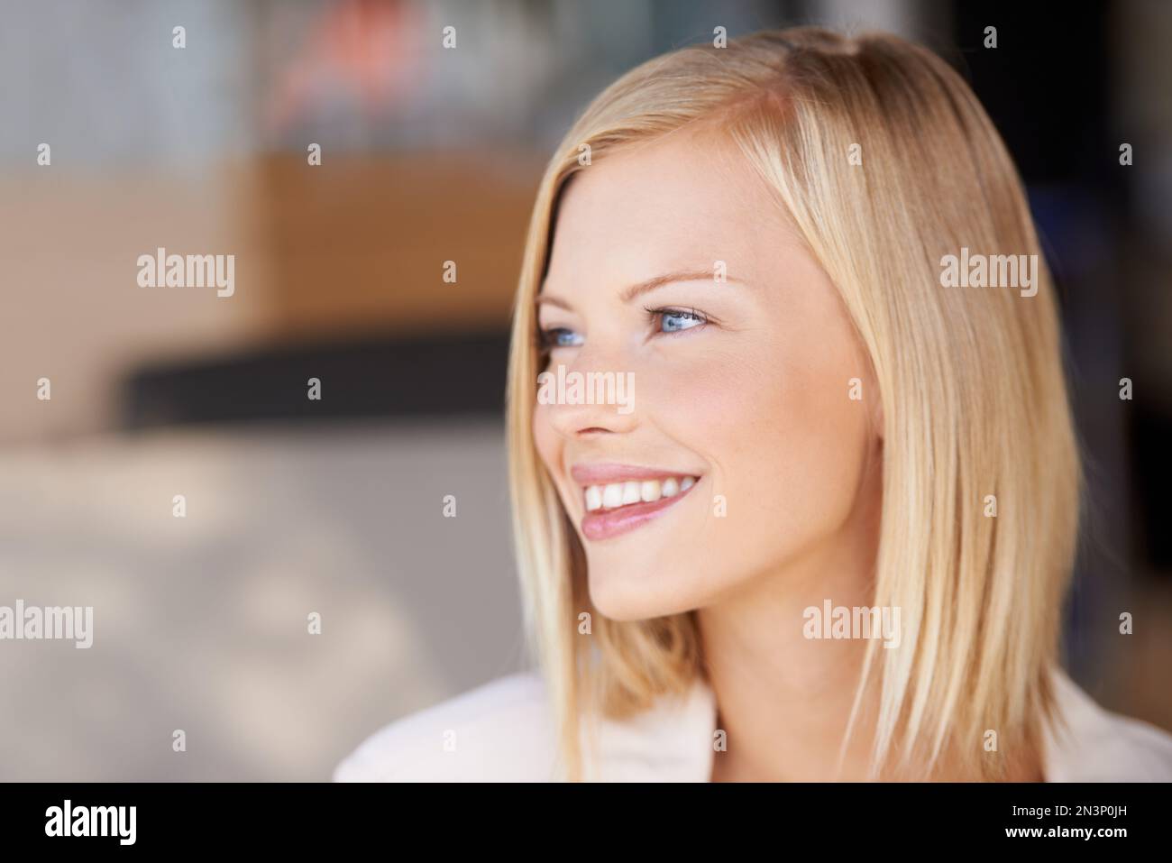Facing the future with a smile. A gorgeous young woman laughing as she ...