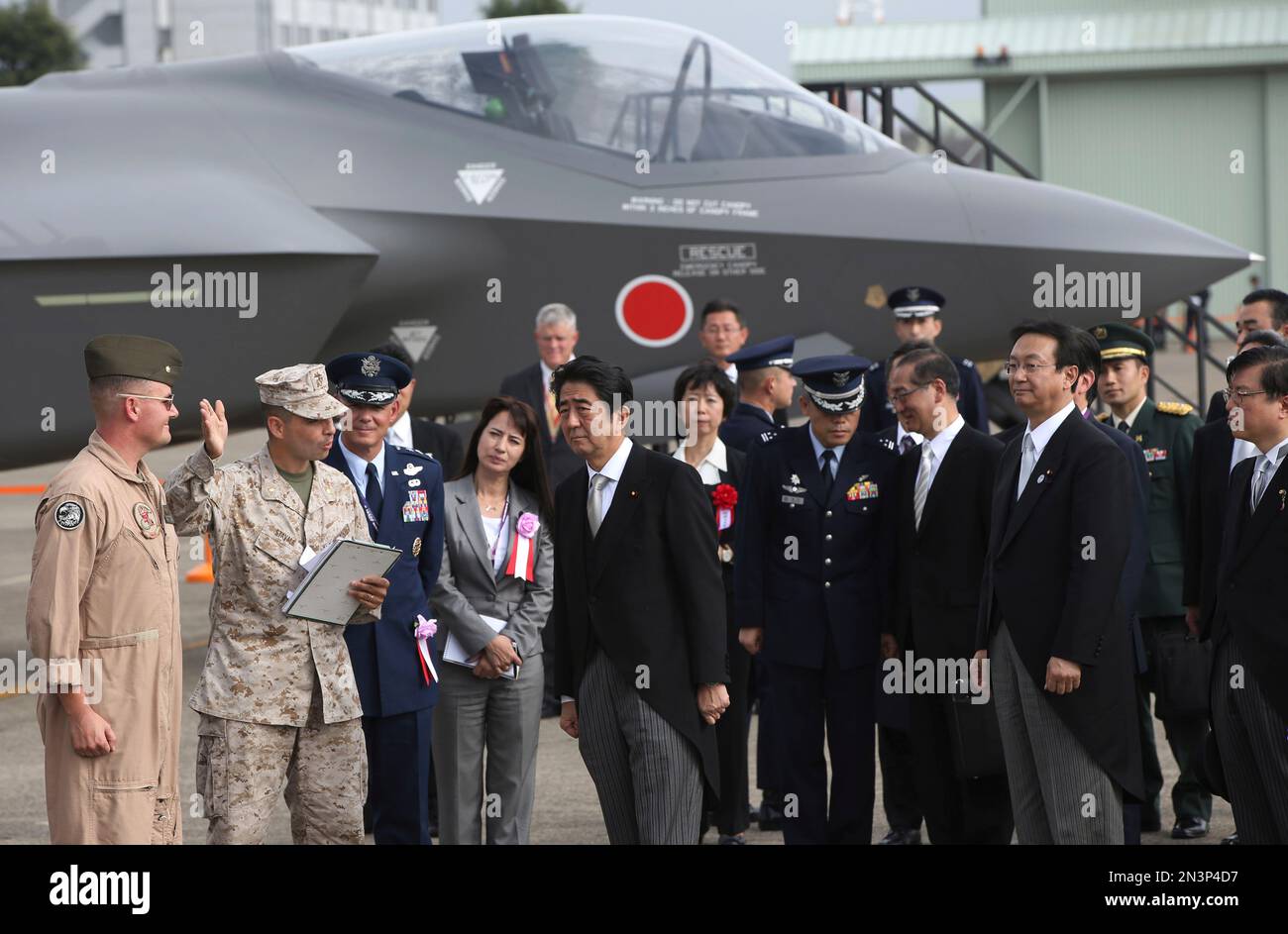 Japanese Prime Minister Shinzo Abe, fifth from left, is guided by U.S ...