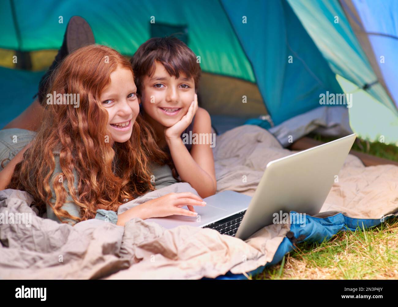 Accessing the web from the wilderness. A young brother and sister ...