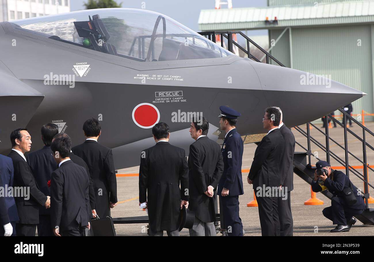 Japanese Prime Minister Shinzo Abe, fifth from right, looks at a mock ...