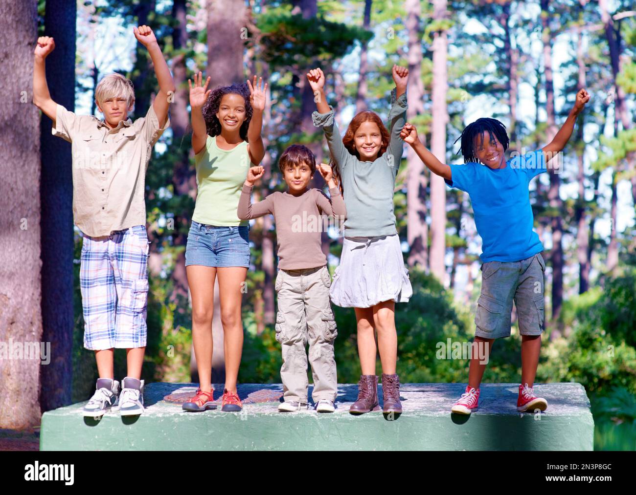 Their future looks bright. A group of happy children cheering while ...