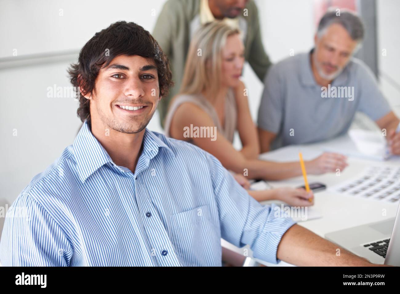 Coming up with great ideas. A group of designers sitting around a ...